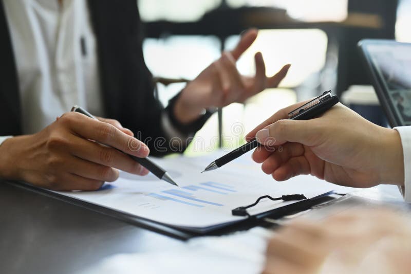 Professional Business Team Discussing and Working with Financial Graph ...