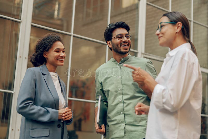 Professional Business Team Talks during Break Standing on Background of ...