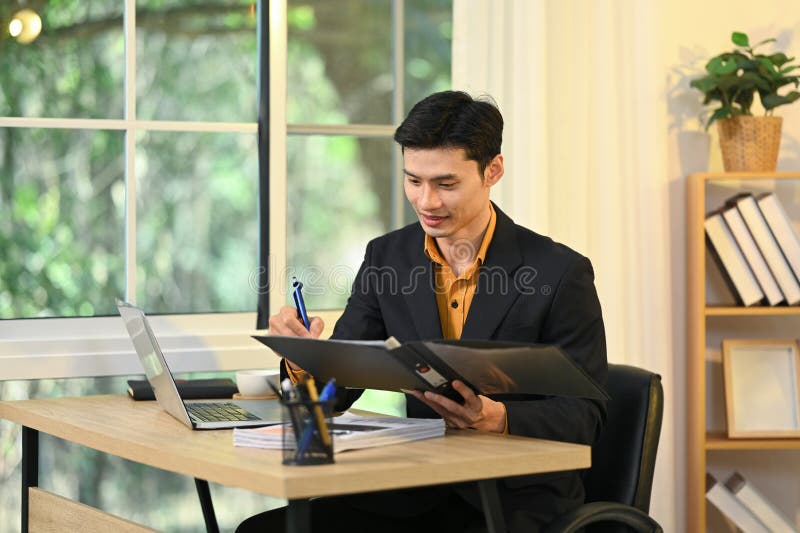 Professional Businessman Checking Reports at His Modern Workplace Stock ...