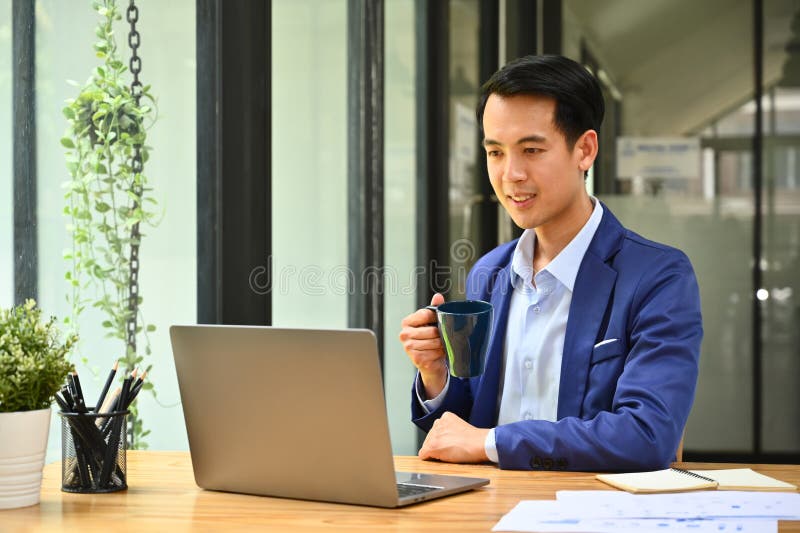 Professional Businessman Drinking Coffee and Checking Email on Laptop ...