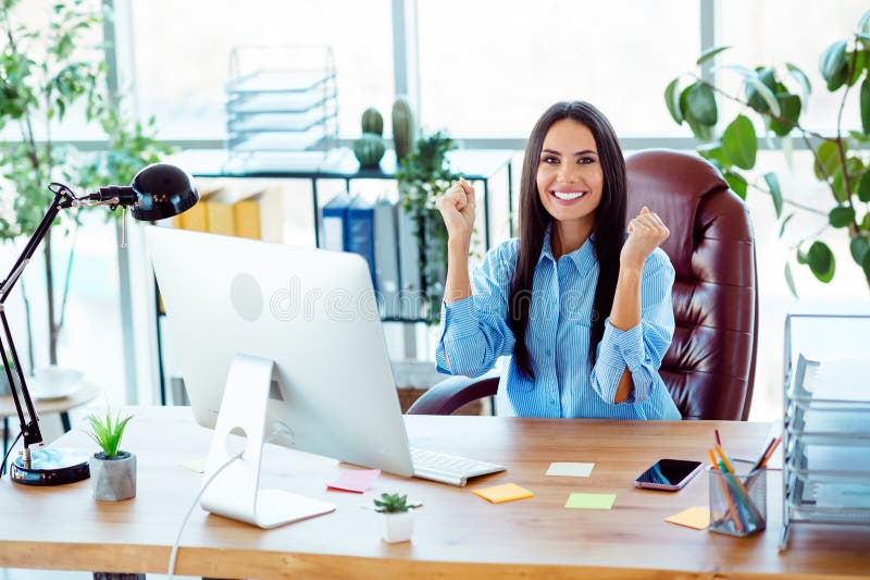 Young Businesswoman Celebrating Success in Modern Office Space, Seated ...