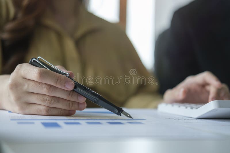 Professional Businesswoman Using Calculator and Analysing Financial ...