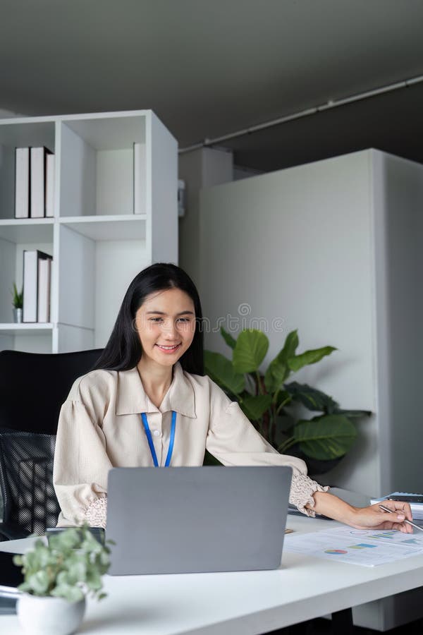 Professional Businesswomen Submitting Work on Laptop in Modern Office ...