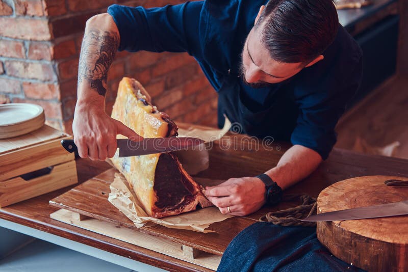 Professional Butcher is Cutting Raw Smoked Meat on a Table for C Stock ...