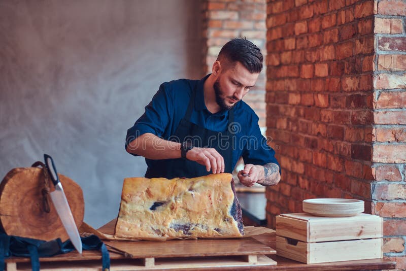 Professional Butcher is Cutting Raw Smoked Meat on a Table for C Stock ...