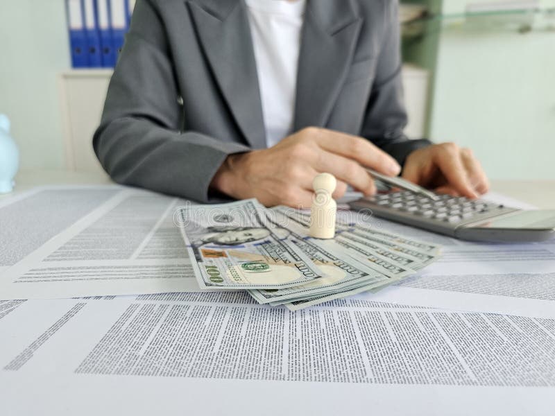 Professional Calculating Costs while Reviewing Financial Documents and ...