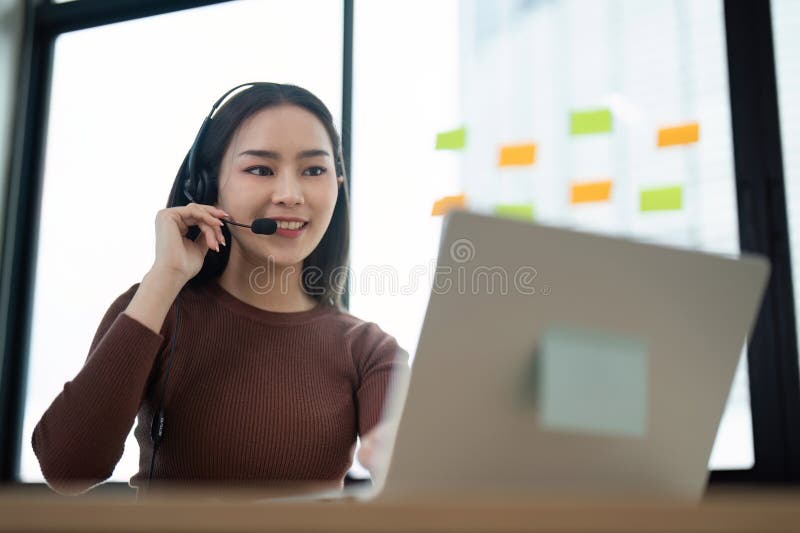 Professional Call Center Agent Working on Laptop with Headset in Modern ...