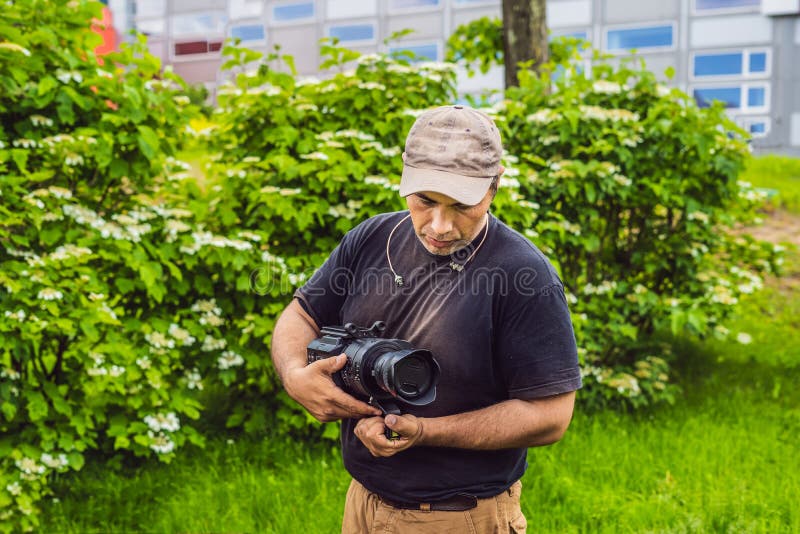 A Professional Cameraman Prepares a Camera and a Tripod before Shooting ...
