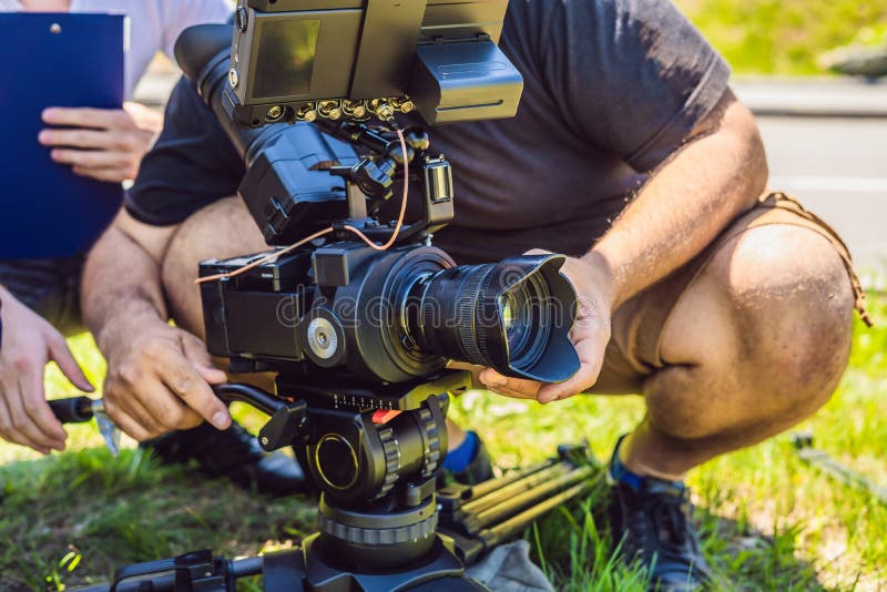 A Professional Cameraman Prepares a Camera and a Tripod before Shooting ...