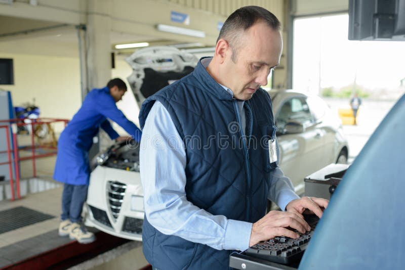 Professional Car Mechanic at Workplace Using Laptop Stock Image - Image ...