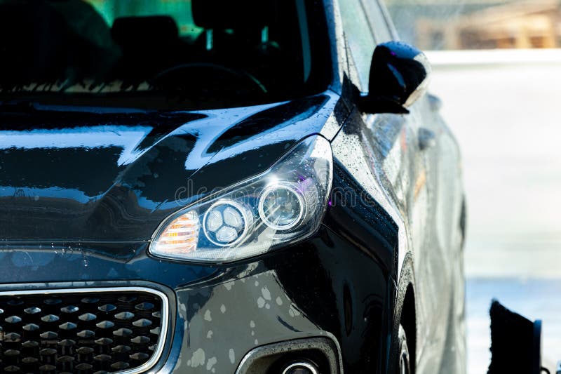 Professional Car Wash Cleaning a Shiny Black Car To Remove Dirt Stock ...