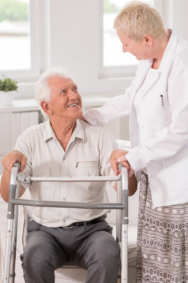 Carer helping senior woman stock image. Image of pensioner - 66034769