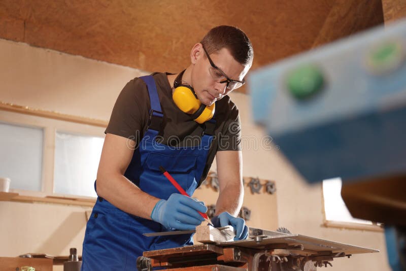 Professional Carpenter Making Mark on Bar in Workshop Stock Photo ...
