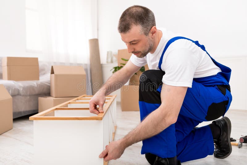Professional Carpenter Man Repairing Shelf Assembling Furniture Indoors