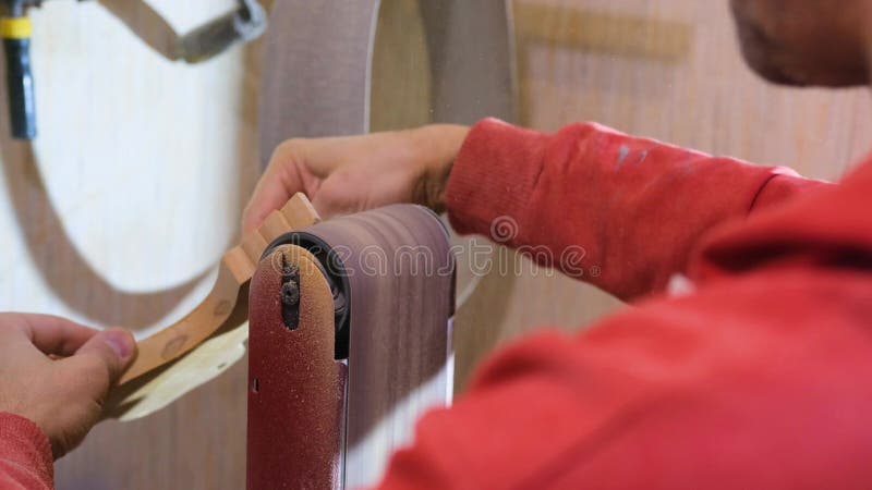 A Professional Carpenter Processes a Wooden Billet with a Belt Grinder ...