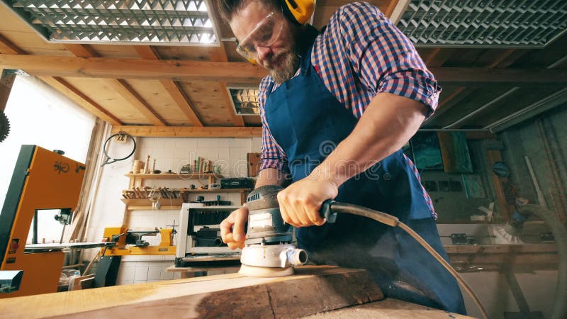 Professional Carpenter Uses Sanding Machine, Working with Wood in a ...