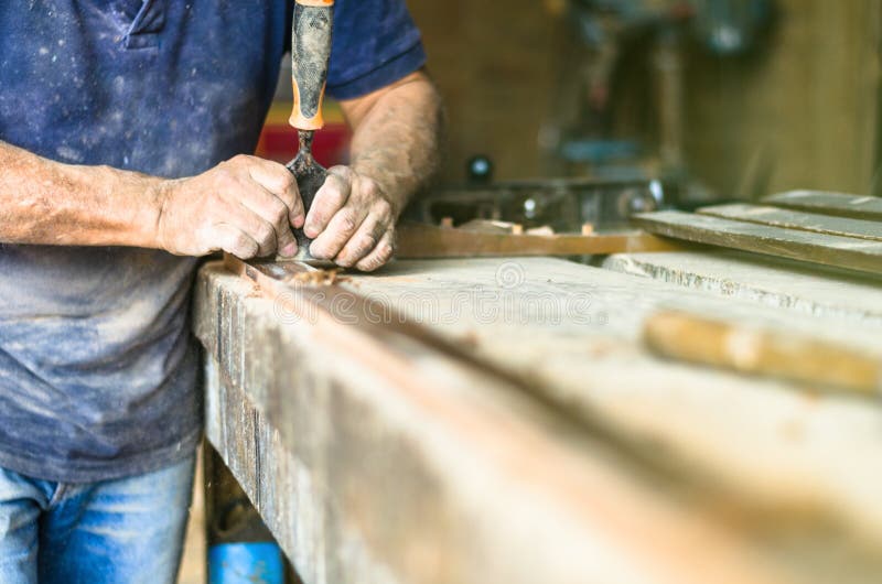 Professional Carpenter at Work, he is Carving Wood Using a Woodworking ...