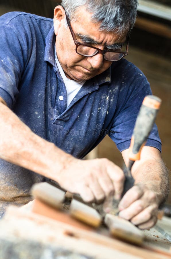 Professional Carpenter at Work, he is Carving Wood Using a Woodworking ...