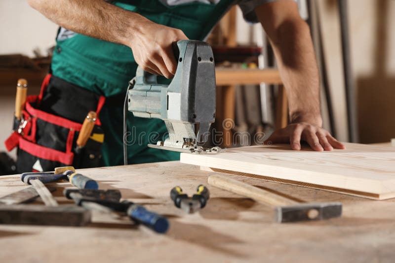 Professional Carpenter Working with Jigsaw at Workbench Stock Photo ...
