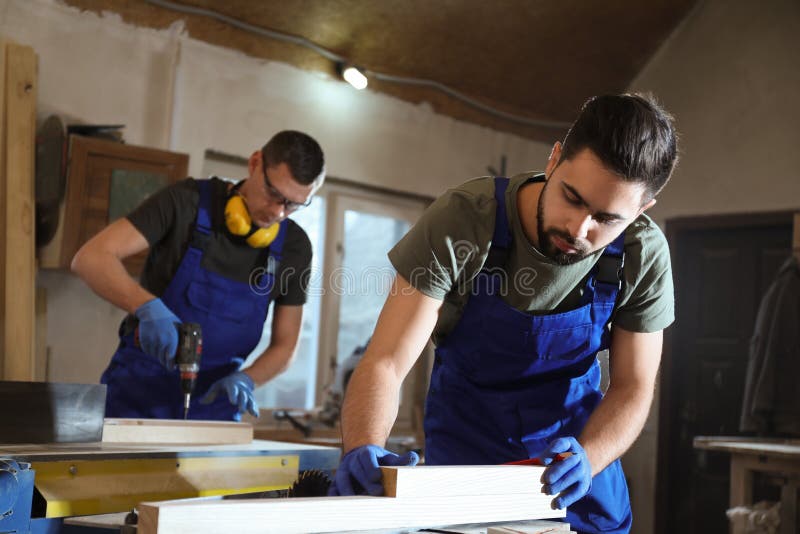Professional Carpenters Working with Wood in Shop Stock Photo - Image ...