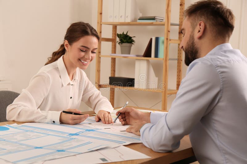 Professional Cartographers Working with Cadastral Map at Table in ...