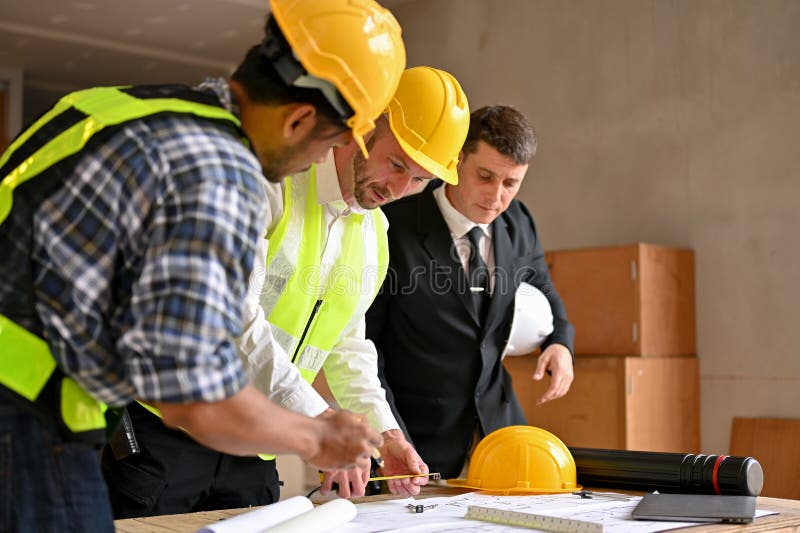 Group of Construction Engineer Working at the Construction Site with a ...