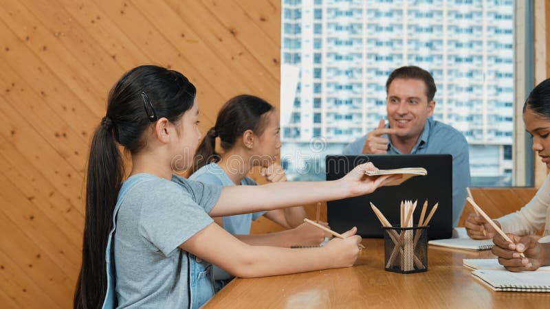 Smart Teacher Explain Homework while Diverse Student Doing Test ...