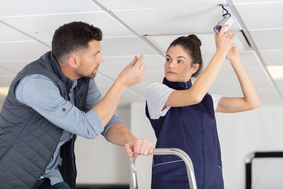 Professional Cctv Technician Working with Female Apprentice Stock Image ...