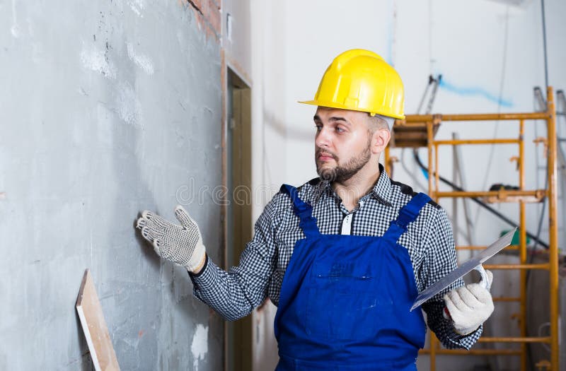 Professional is Checking the Quality of the Work Done after the Plaster ...