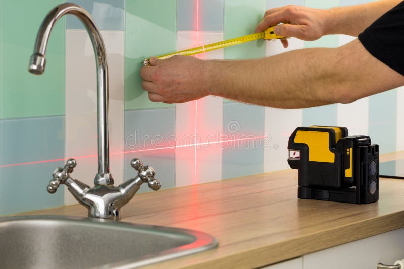 A Professional Checks the Angles while Taking Measurements of the ...