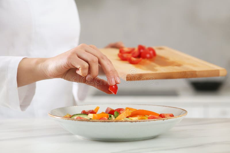 Professional Chef Adding Cut Tomato into Delicious Salad at White ...