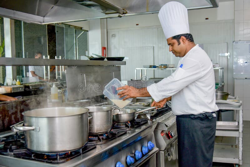 Chef Adding the Final Touch To Paella, the Shells Editorial Image ...