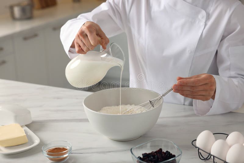 Professional Chef Adding Milk into Dough at White Marble Table Indoors ...