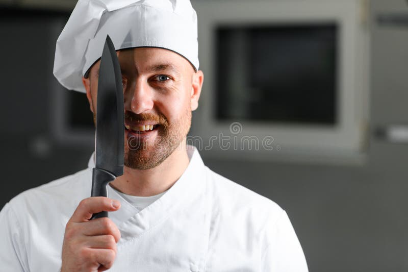 Professional Chef with a Beard in a White Uniform with a Kitchen Knife ...