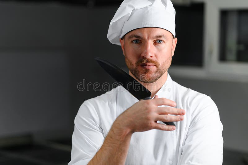 Professional Chef with a Beard in a White Uniform with a Kitchen Knife ...