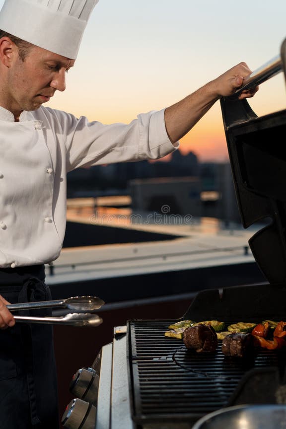 Professional Chef Cooking Bbq on Rooftop at Sunset Stock Photo - Image ...