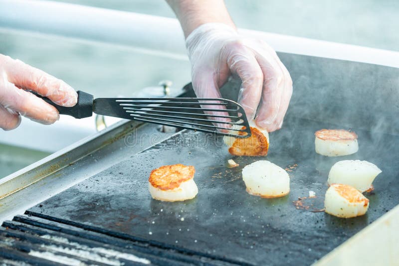 Professional Chef Cooking Fish on a Barbeque. Portionally Fried Pieces ...