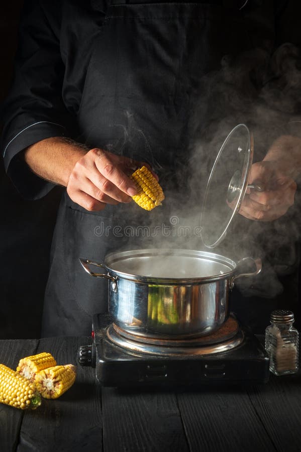 A Professional Chef Cooks Corn. Close-up of a Chef is a Hand while ...