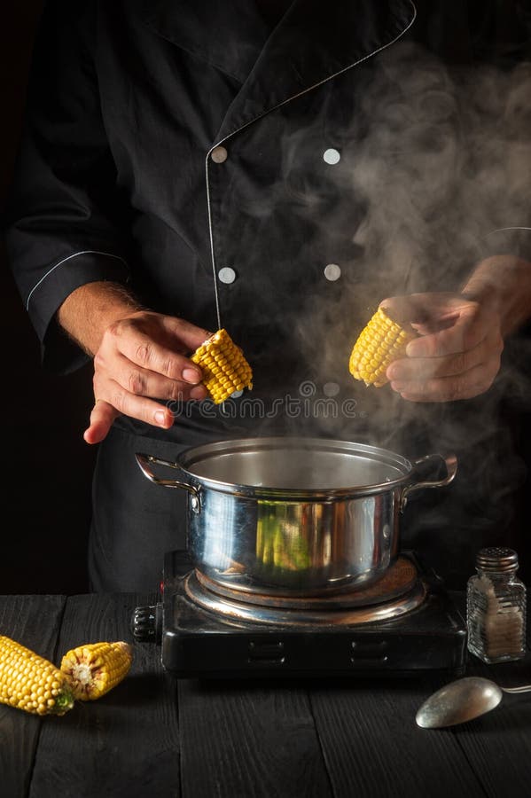 The Professional Chef Cooks Corn. Close-up of a Cook is a Hand while ...