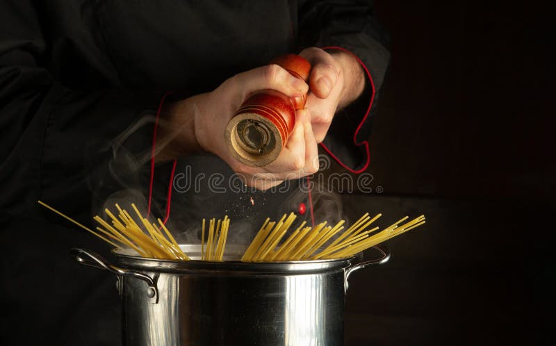 Professional Chef Cooks Spaghetti in Pot with Steam in the Kitchen ...