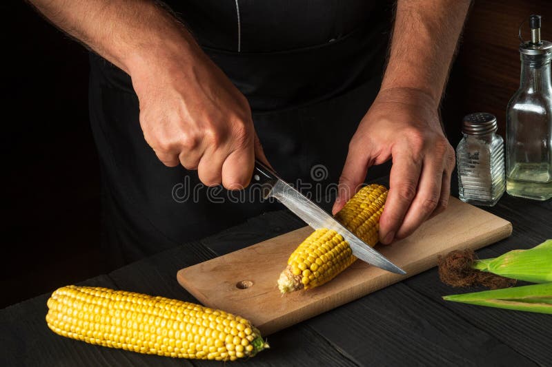 Professional Chef Cuts Fresh Corn with a Knife. Boiled Corn is a Great ...