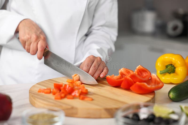 Professional Chef Cutting Pepper at Table in Kitchen, Closeup Stock ...