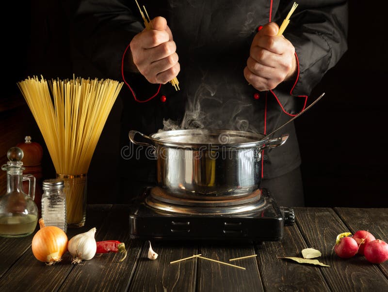 Professional Chef Prepares Italian Pasta. the Cook Keeps Spaghetti in ...
