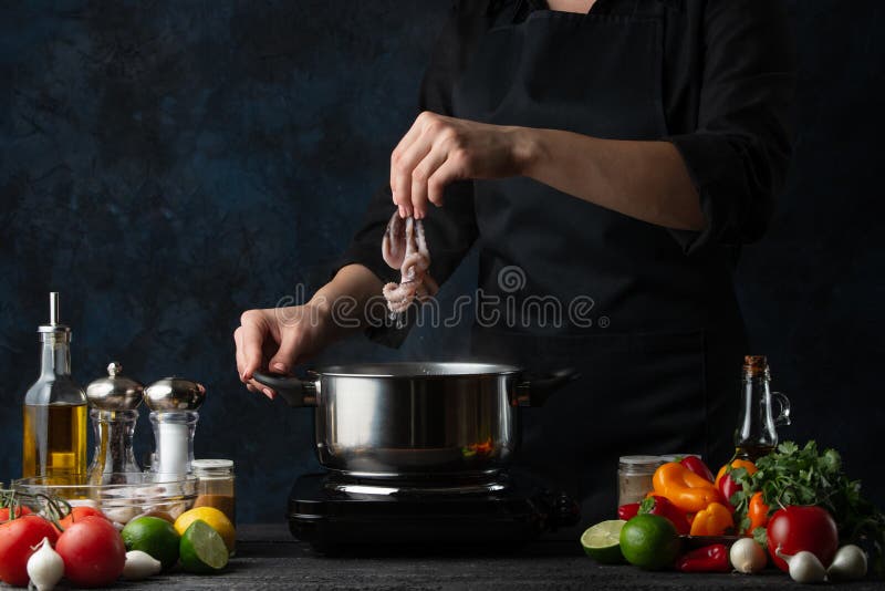 The Professional Chef Puts Raw Octopus into Pan with Boiling Water ...