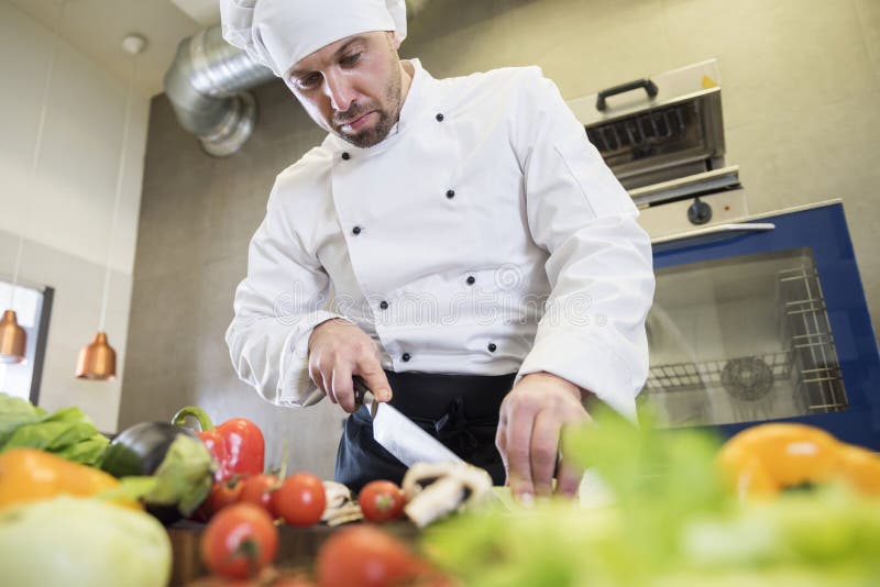 Professional chef at work stock image. Image of cooking - 85336397