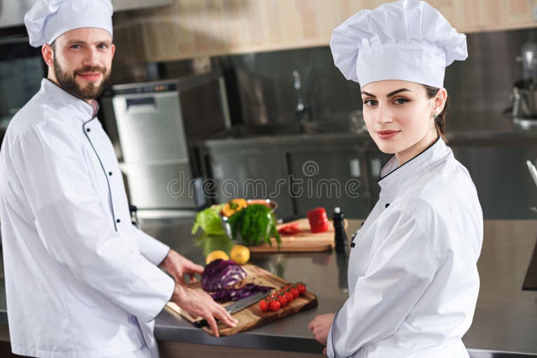 Professional Chefs Looking at Camera by Table Stock Image - Image of ...