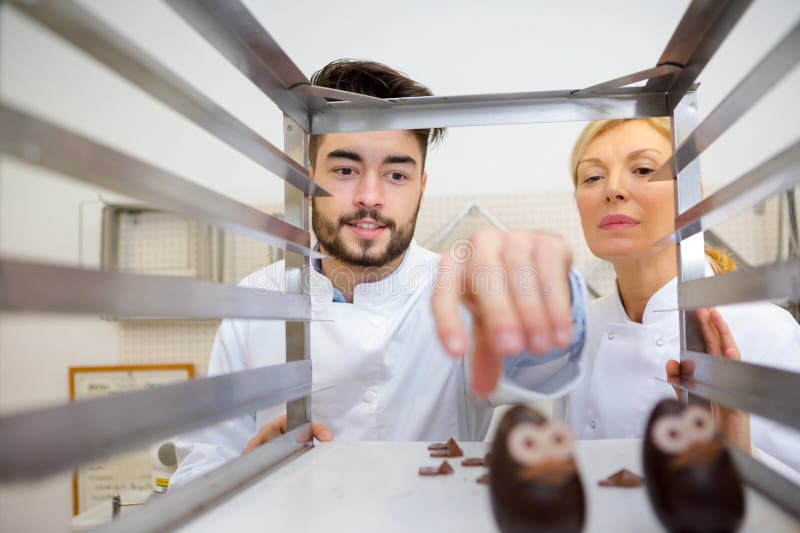 Professional Chefs Looking at Little Novelyty Chocolate Hats Stock ...