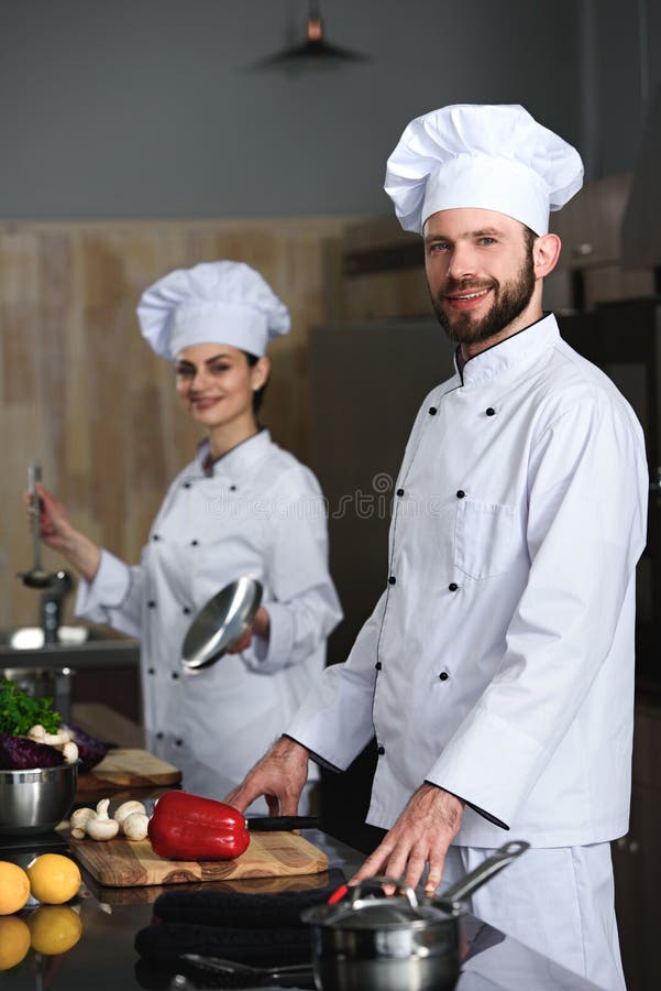 Professional Chefs Man and Woman Cooking Stock Image - Image of cooks ...