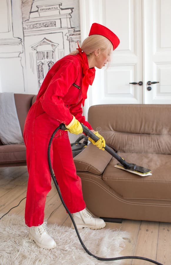 A Professional Cleaner in a Red Uniform at Her Work, with a Steam ...