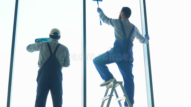 Professional Cleaning Team, Two Multiracial Men Washes Window in Office ...